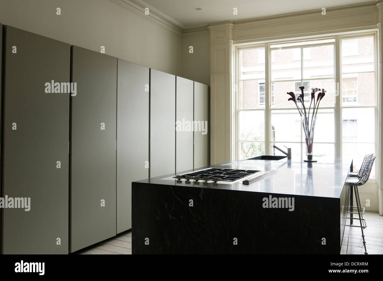 Minotti kitchen with streamlined cupboards and granite island with ...