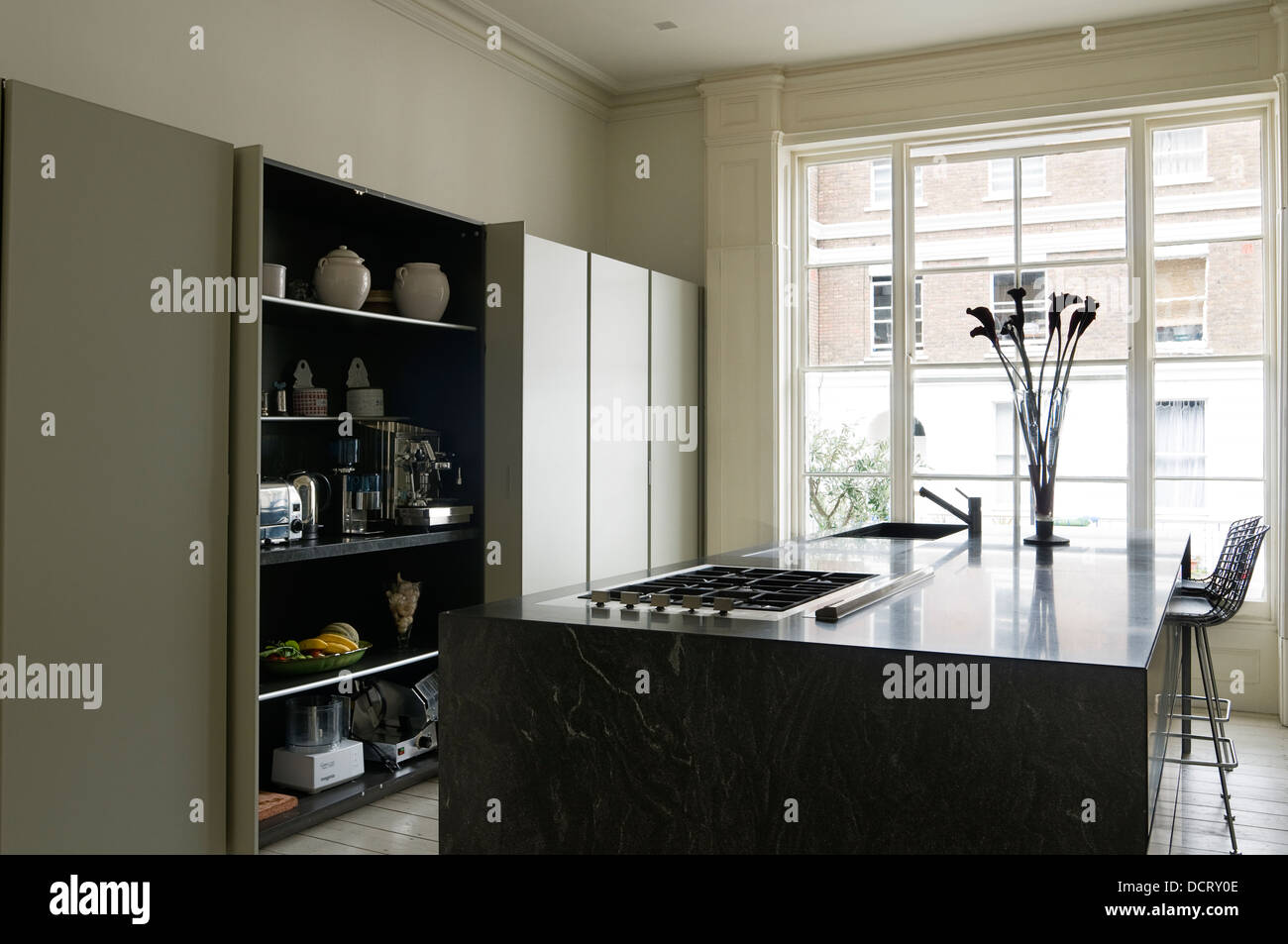 Minotti kitchen with streamlined cupboards and granite island with ...