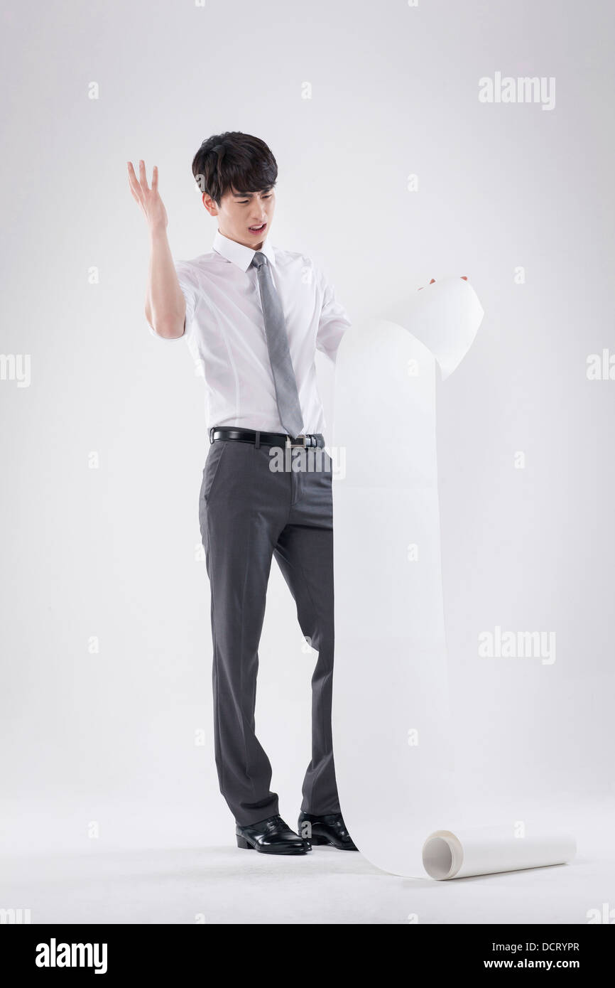 a business man holding a paper roll Stock Photo - Alamy