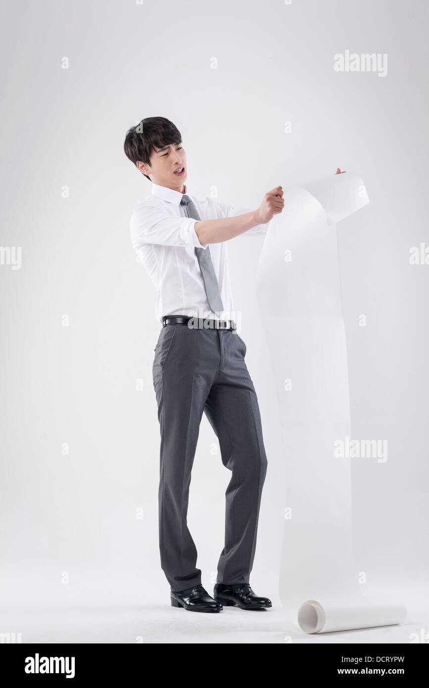 a business man holding a paper roll Stock Photo - Alamy