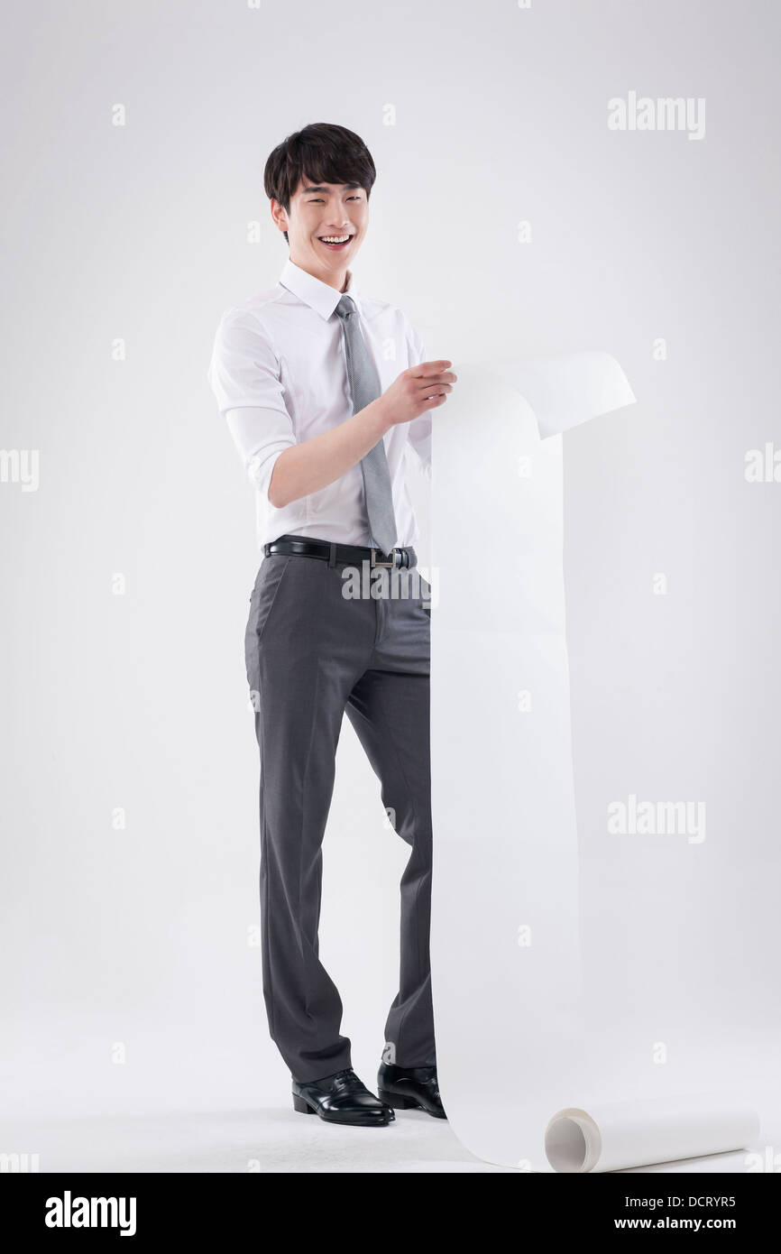 a business man holding a paper roll Stock Photo - Alamy