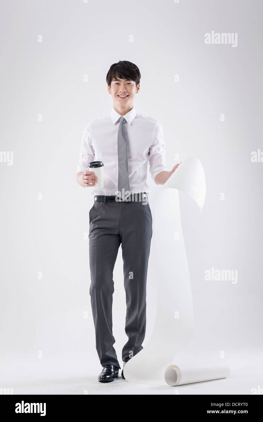 a business man holding a paper roll Stock Photo - Alamy