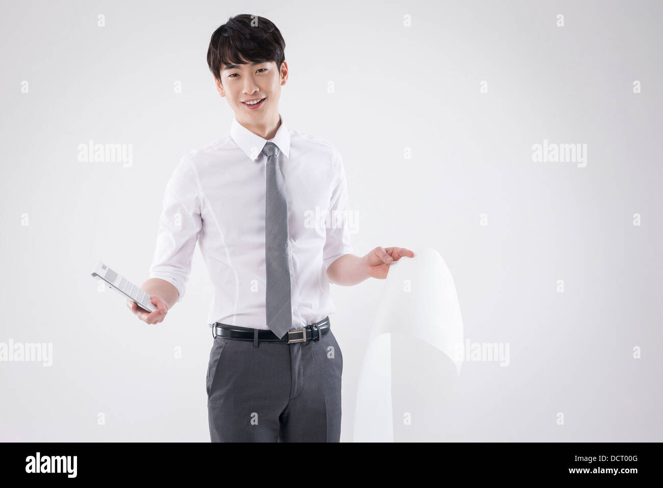 a business man holding a paper roll Stock Photo - Alamy
