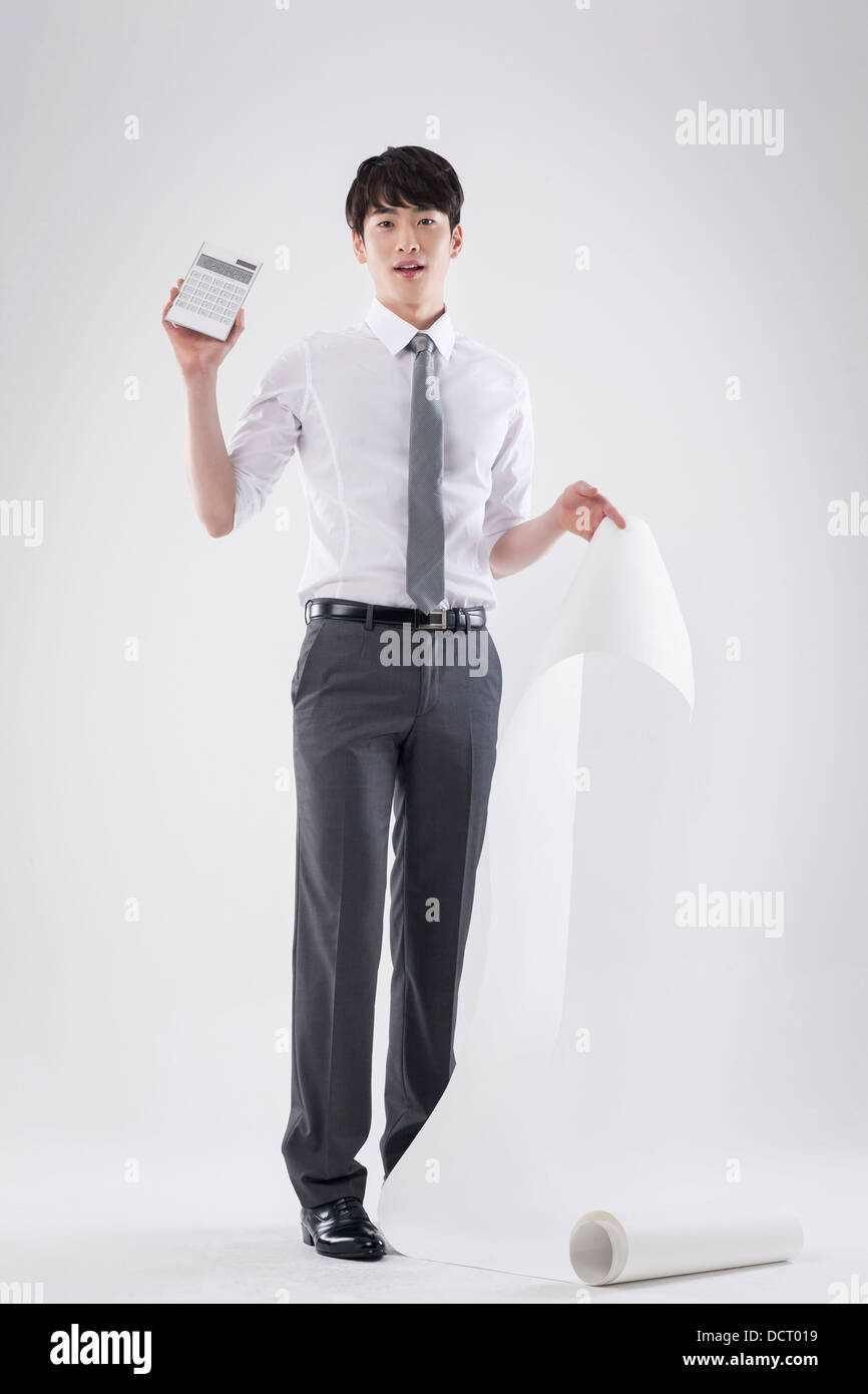 a business man holding a paper roll Stock Photo - Alamy