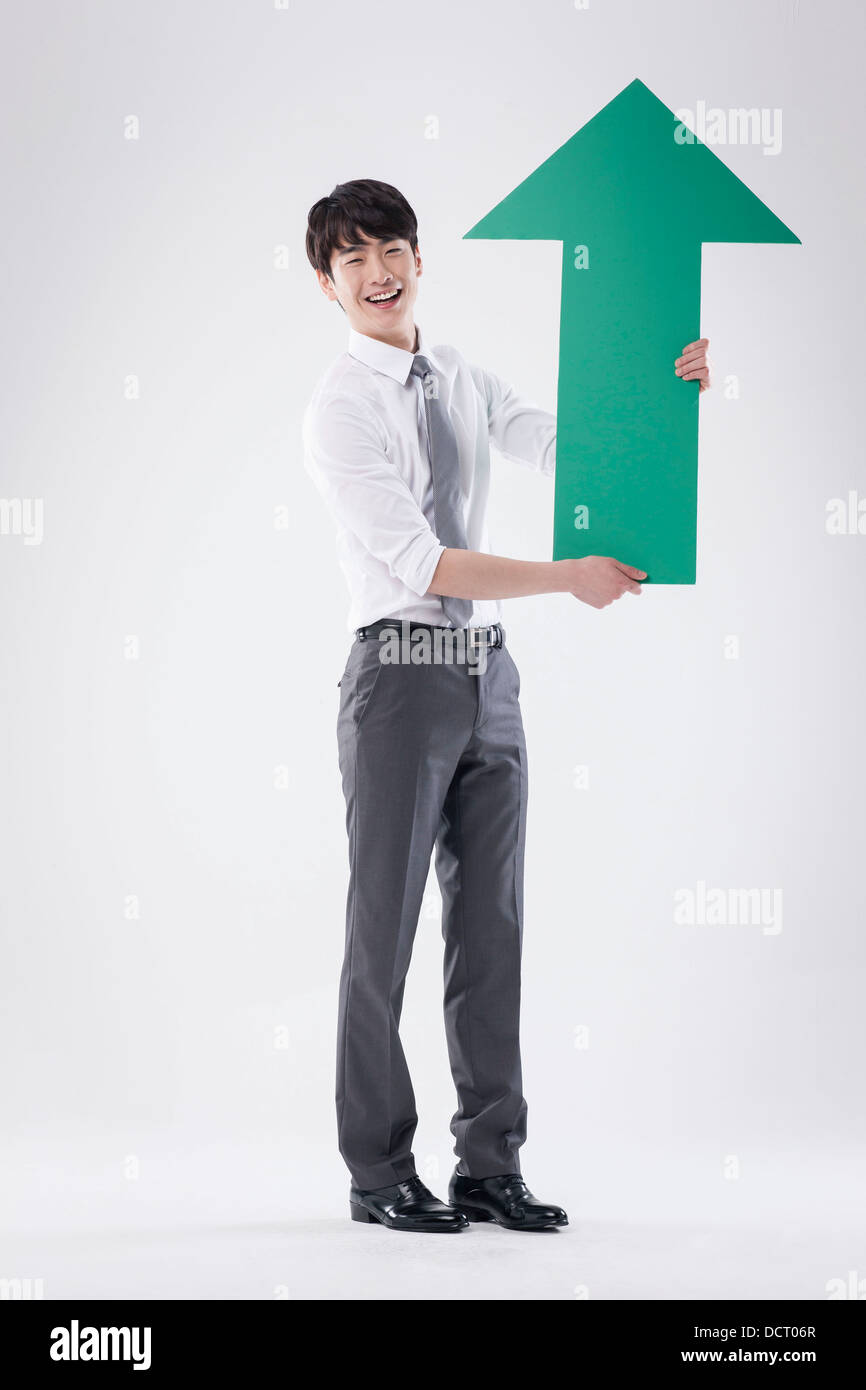 a business man holding an arrow Stock Photo - Alamy
