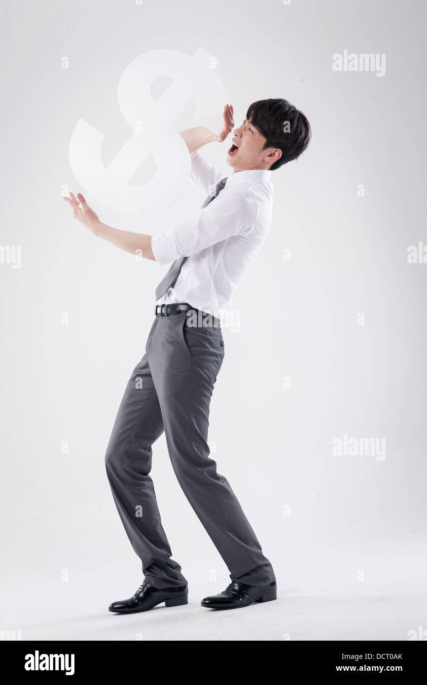 a business man holding a dollar sign Stock Photo - Alamy