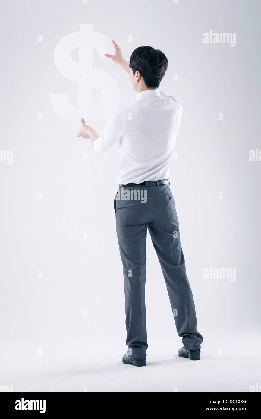 a business man holding a dollar sign Stock Photo - Alamy