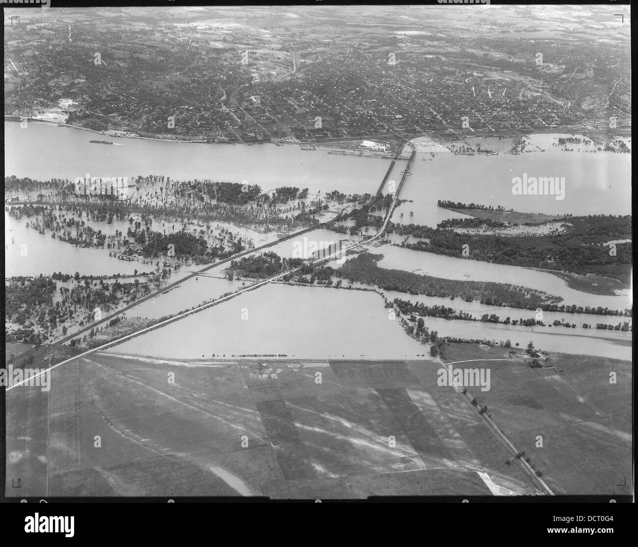 Photograph showing bridges across a flooded river, capturing the ...