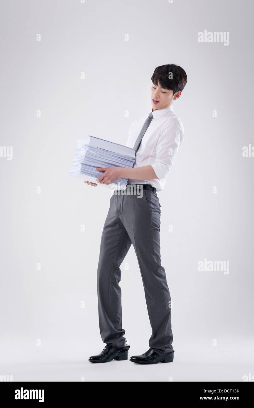 a business man carrying a pile of papers Stock Photo - Alamy