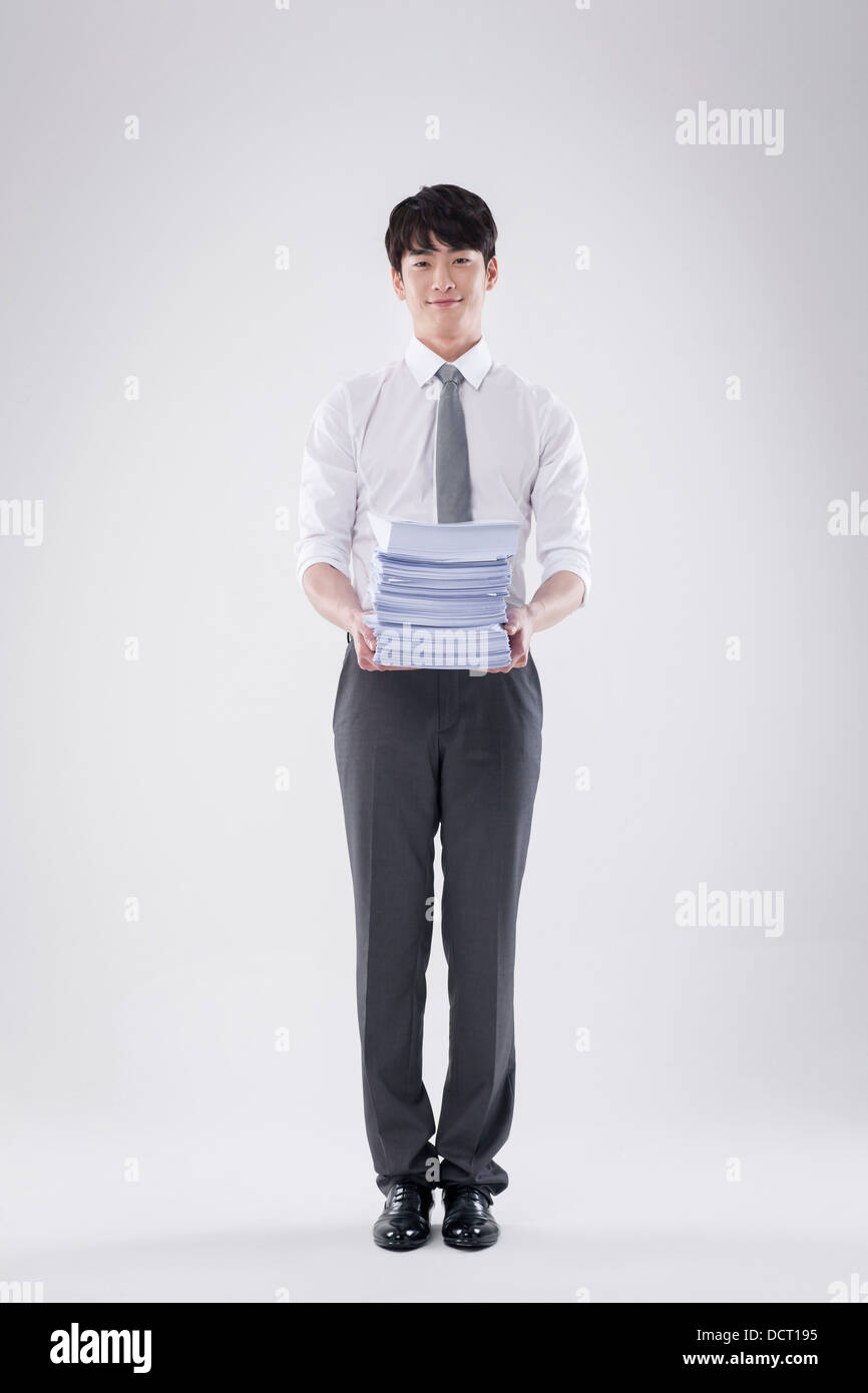 a business man carrying a pile of papers Stock Photo - Alamy