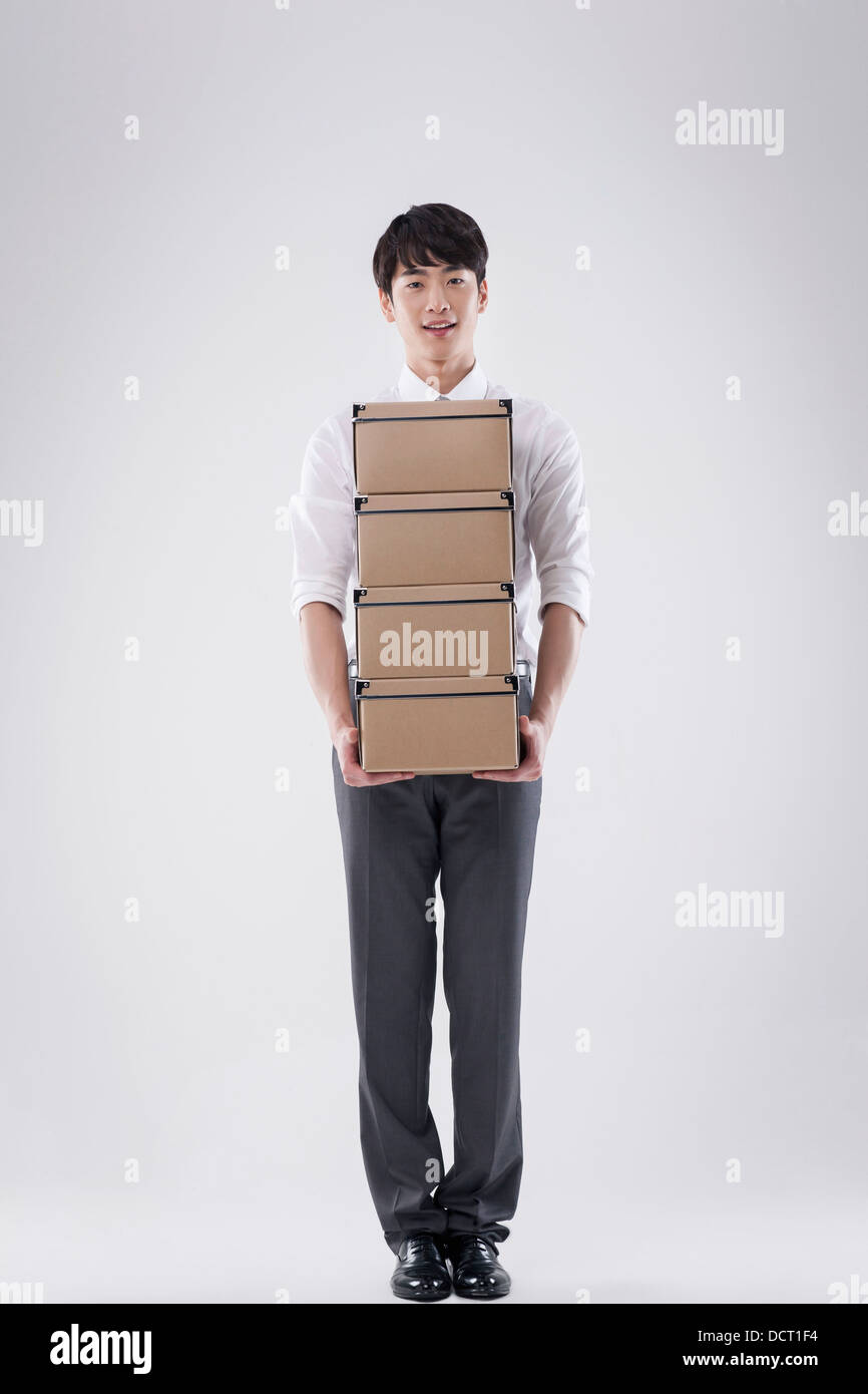 a business man carrying a pile of boxes Stock Photo - Alamy
