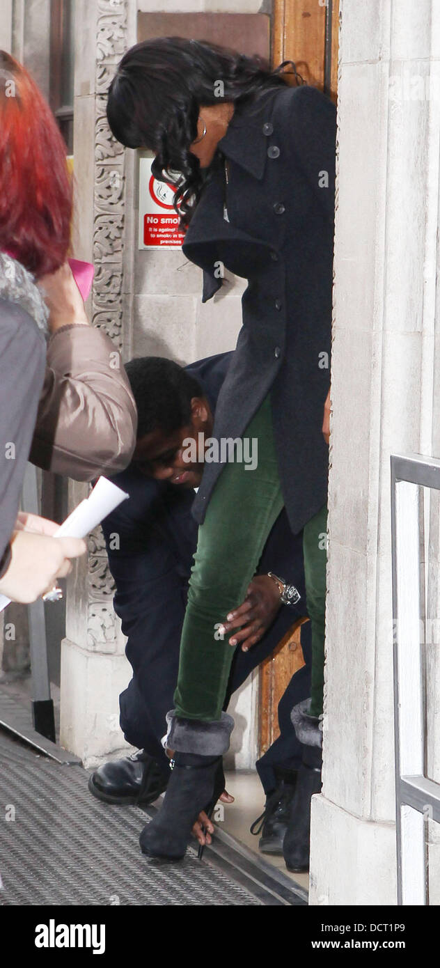 Kelly Rowland gets her heel caught in the ramp as she leaves the BBC ...