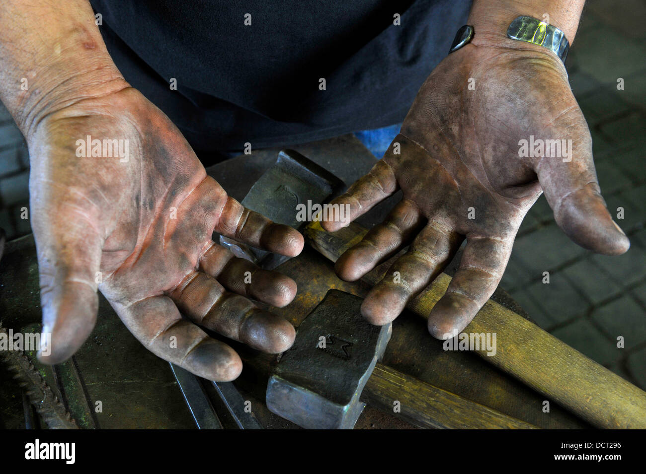 Five forgers from Israel work on metal sculpture of a bird during Forge ...