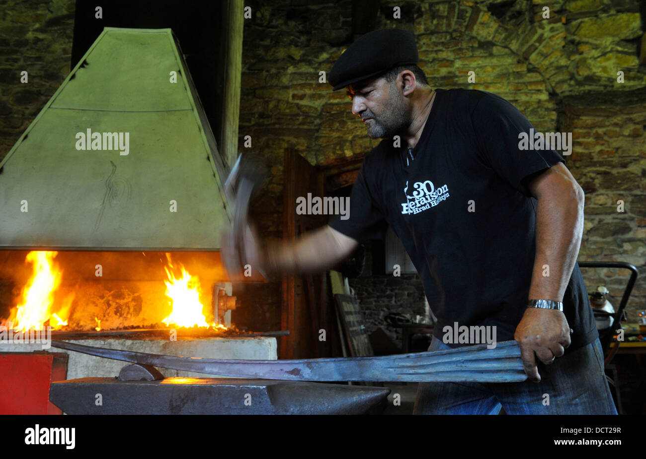 Five forgers from Israel work on metal sculpture of a bird during Forge ...