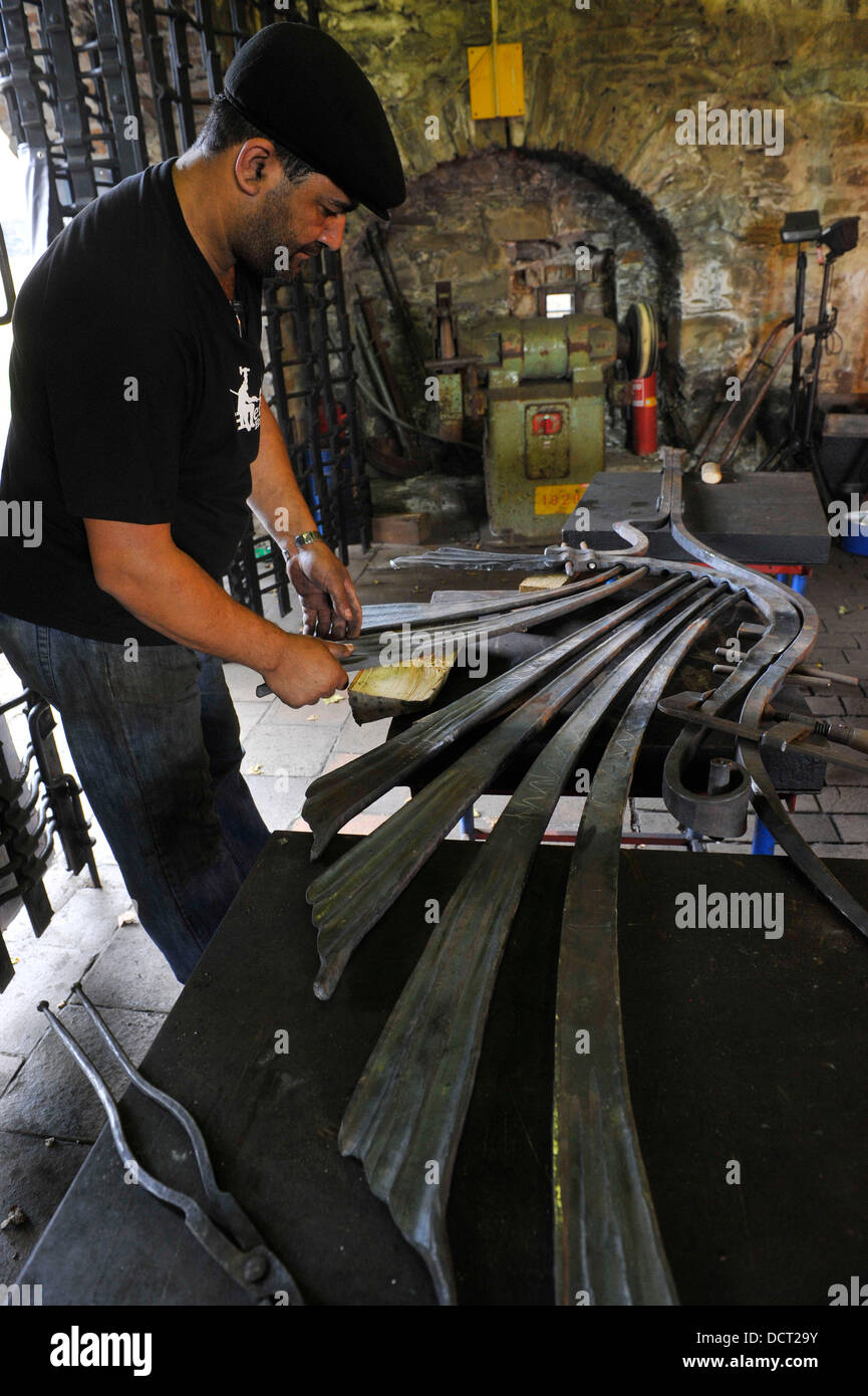 Five forgers from Israel work on metal sculpture of a bird during Forge ...