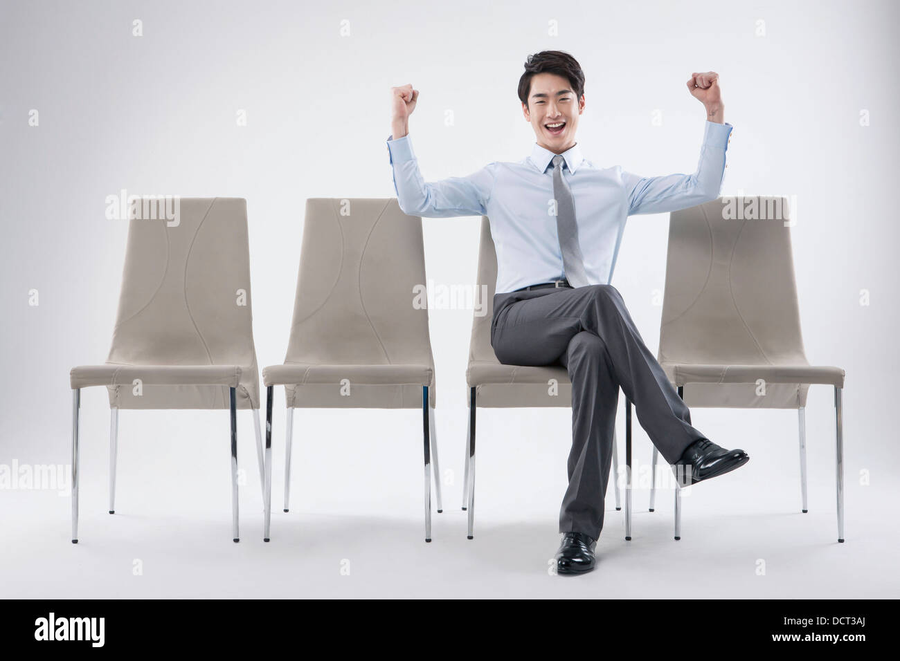 a business man sitting on a chair Stock Photo - Alamy