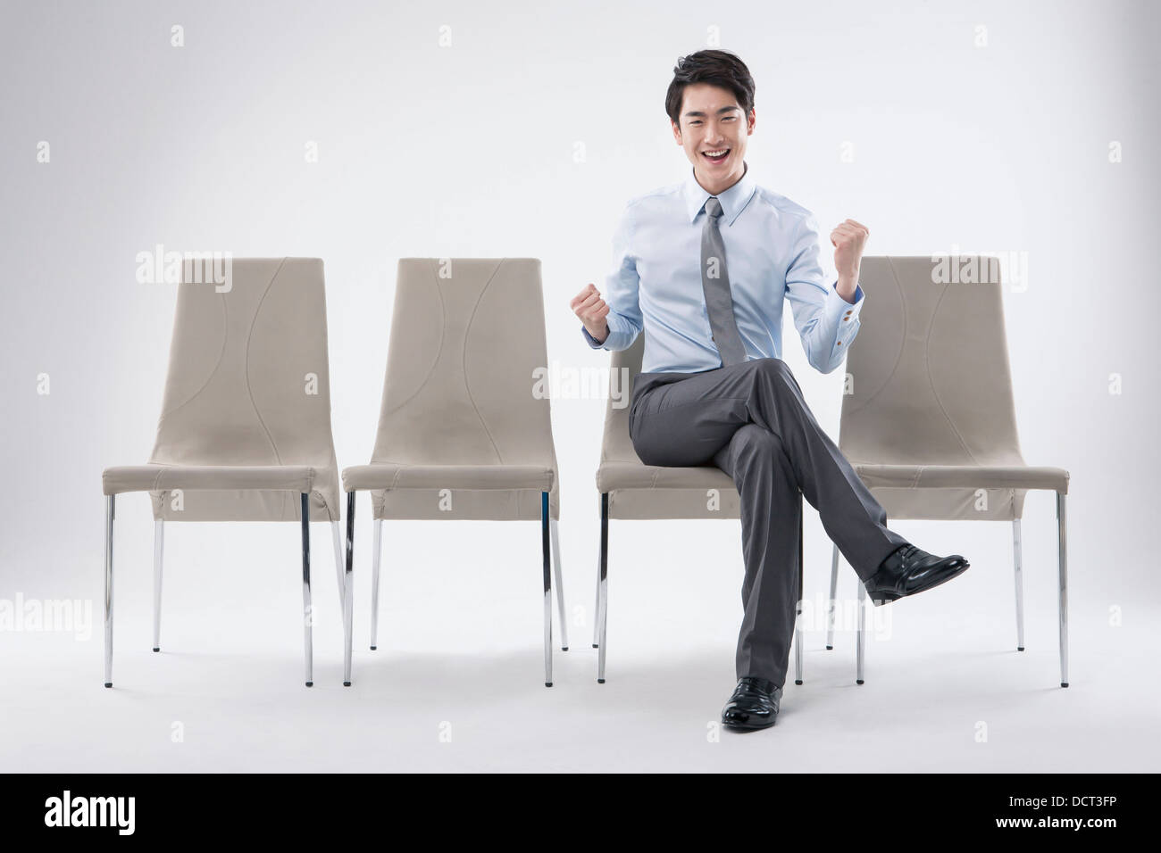 a business man sitting on a chair Stock Photo - Alamy