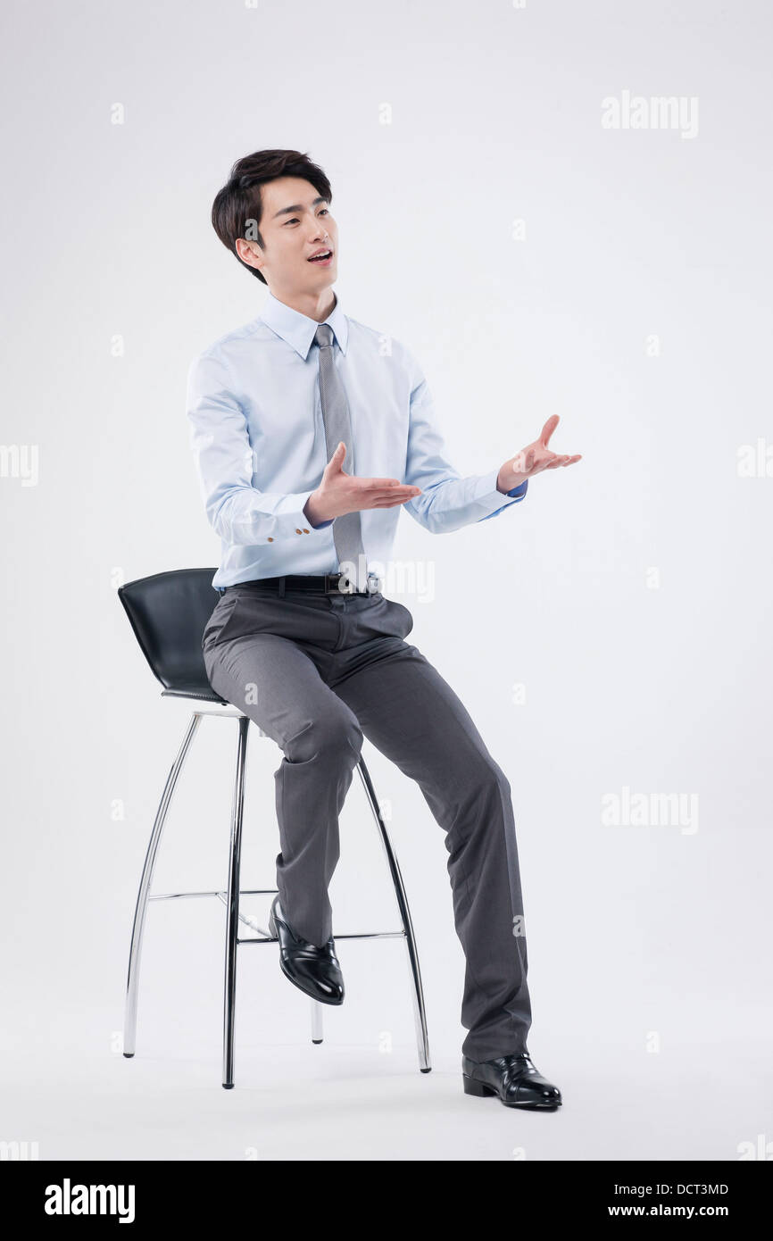 a business man sitting on a chair Stock Photo - Alamy