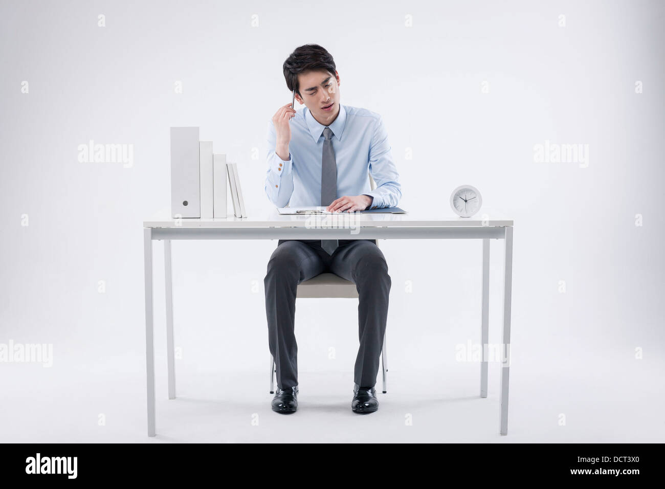 a business man sitting at a desk Stock Photo - Alamy