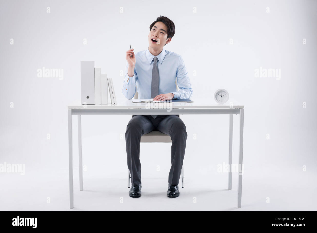 a business man sitting at a desk Stock Photo - Alamy