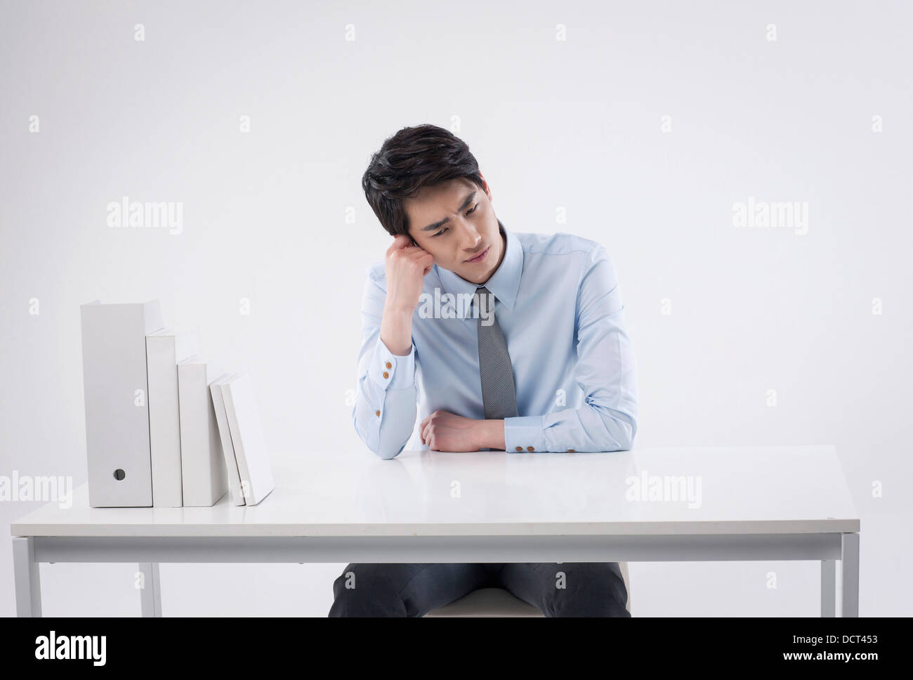 a business man sitting at a desk Stock Photo - Alamy