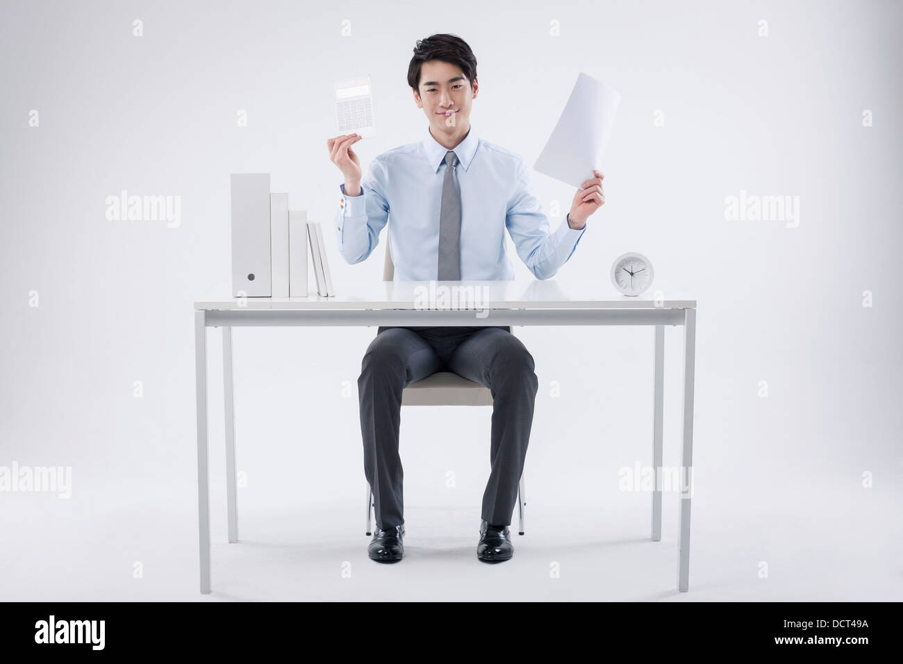a business man sitting at a desk Stock Photo - Alamy