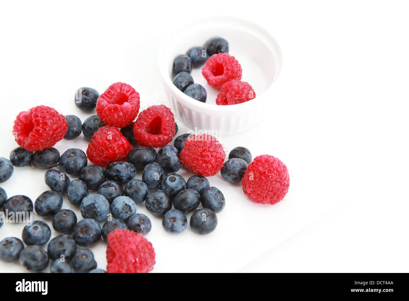 raspberries and blueberries over white Stock Photo - Alamy