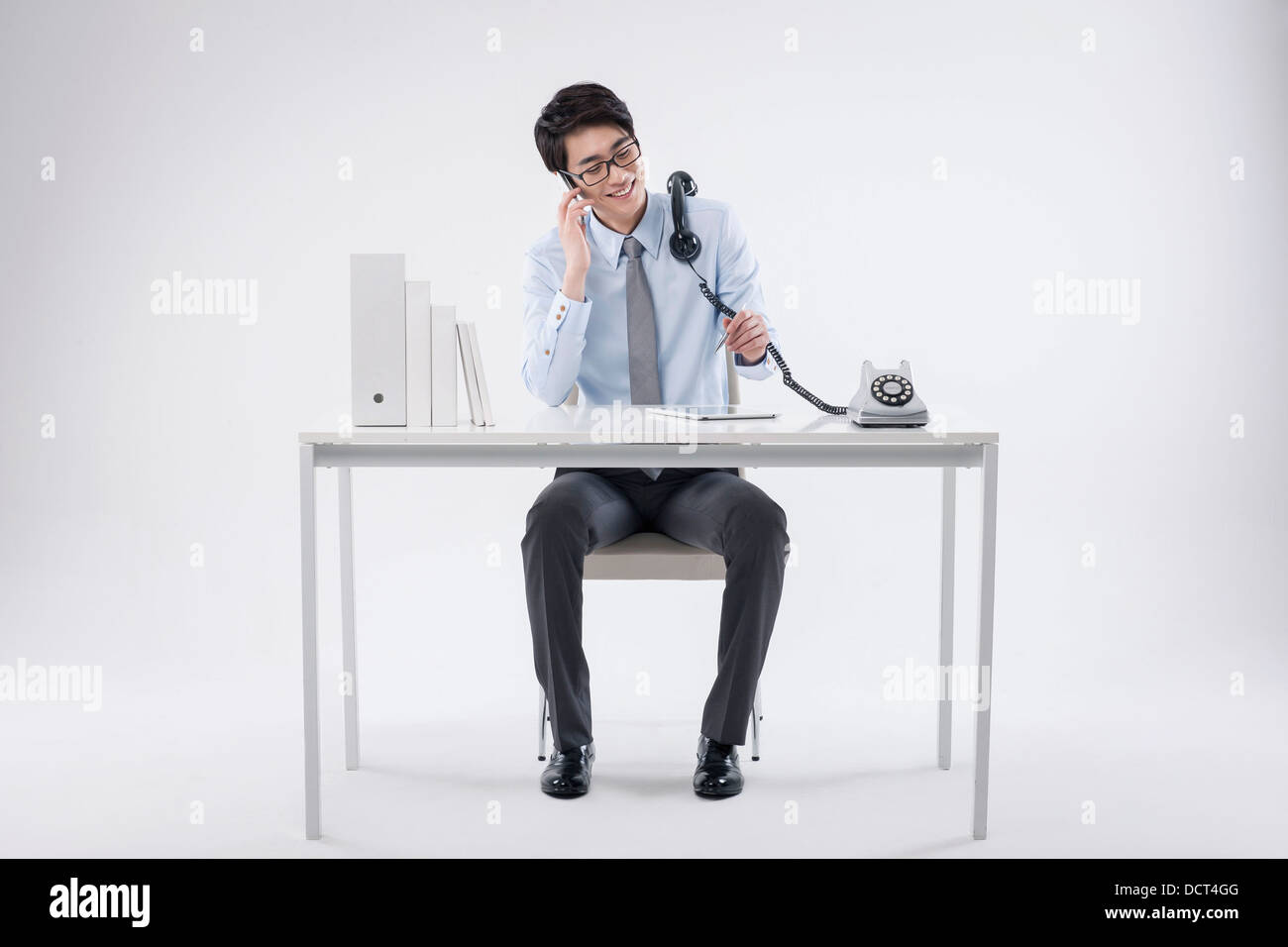 a business man sitting at a desk Stock Photo - Alamy