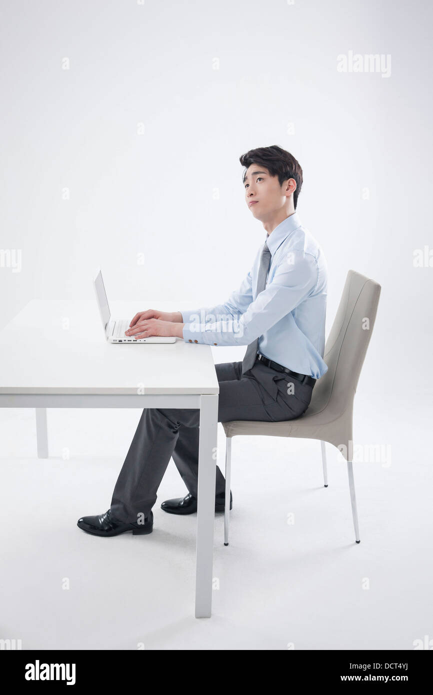 a business man sitting at a desk Stock Photo - Alamy