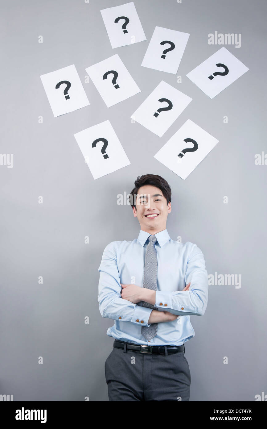 a business man with papers that has a question mark Stock Photo - Alamy