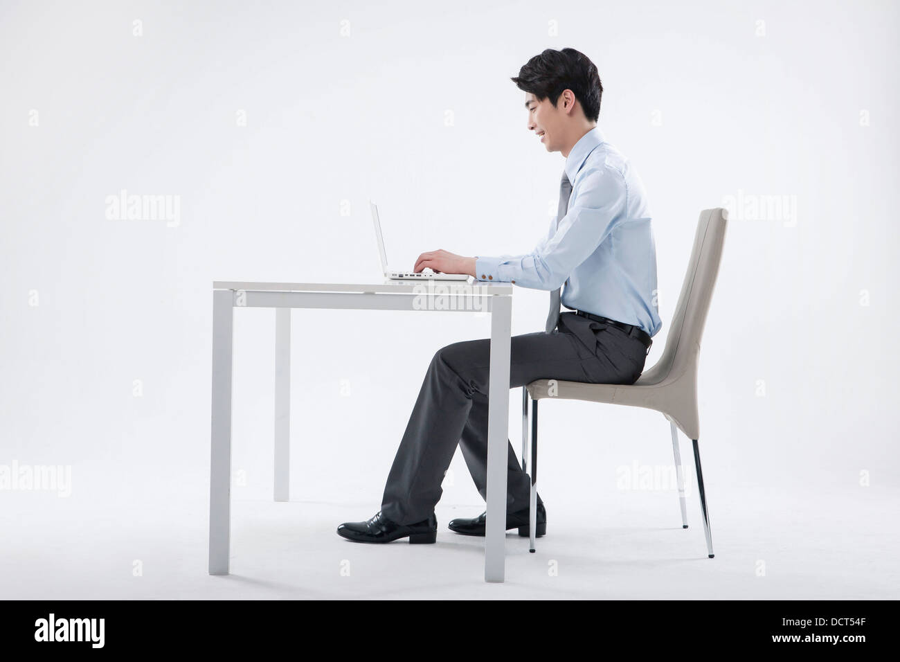 a business man sitting at a desk Stock Photo - Alamy