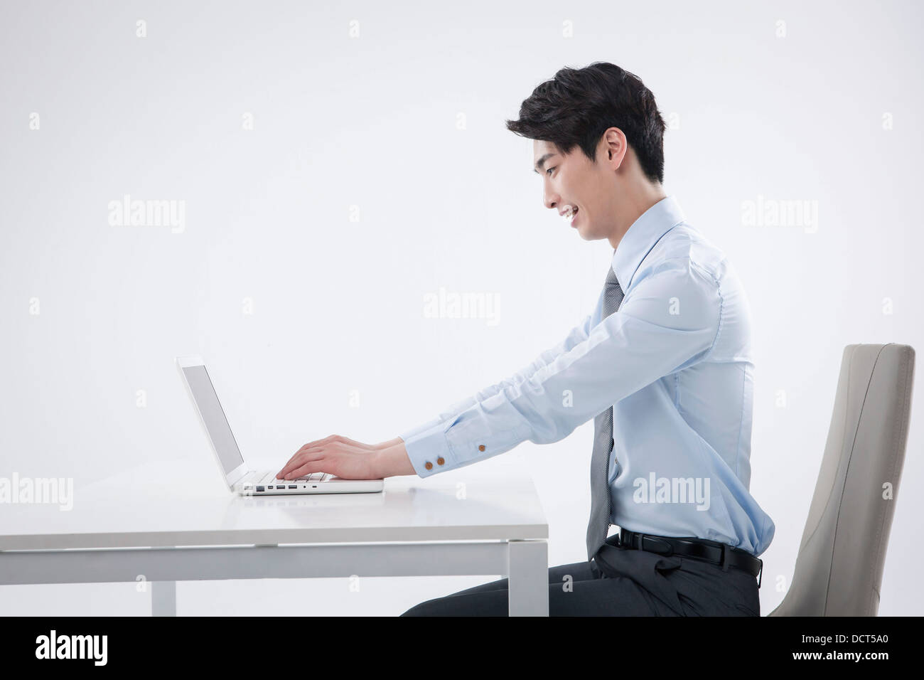 a business man sitting at a desk Stock Photo - Alamy
