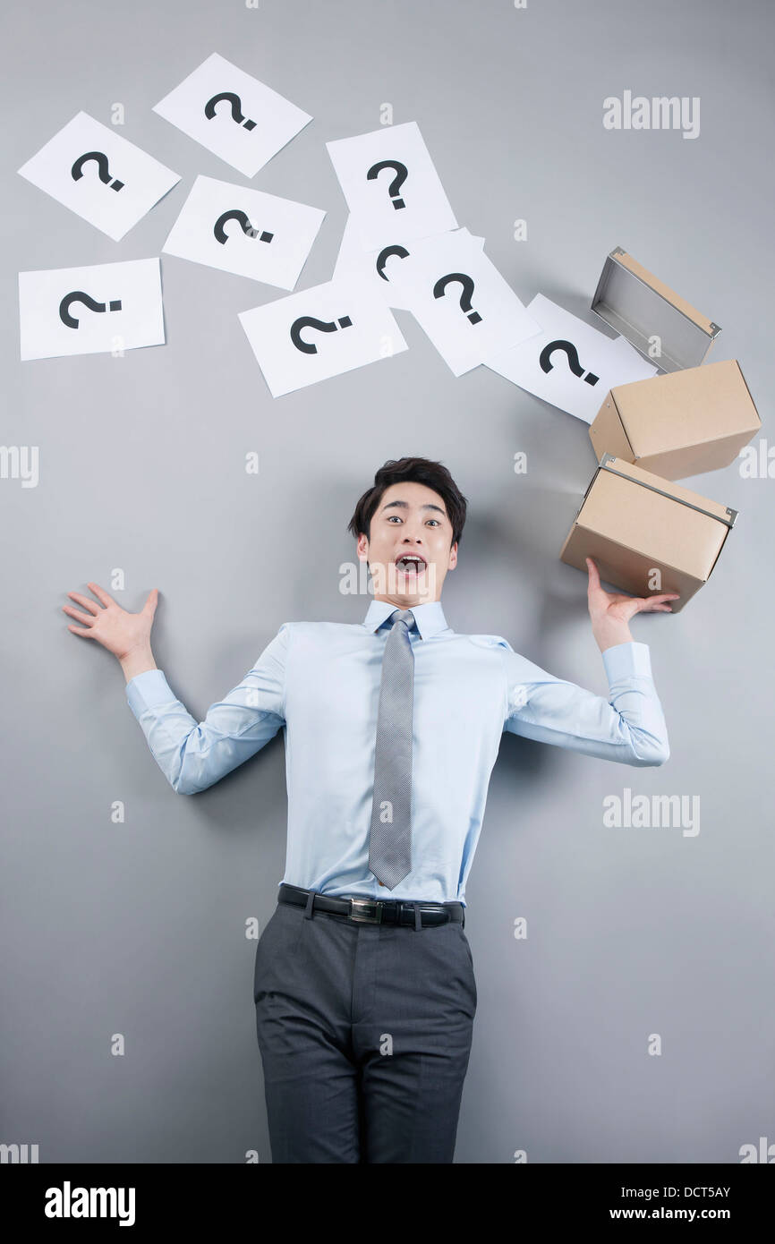 a business man with papers that has a question mark Stock Photo - Alamy
