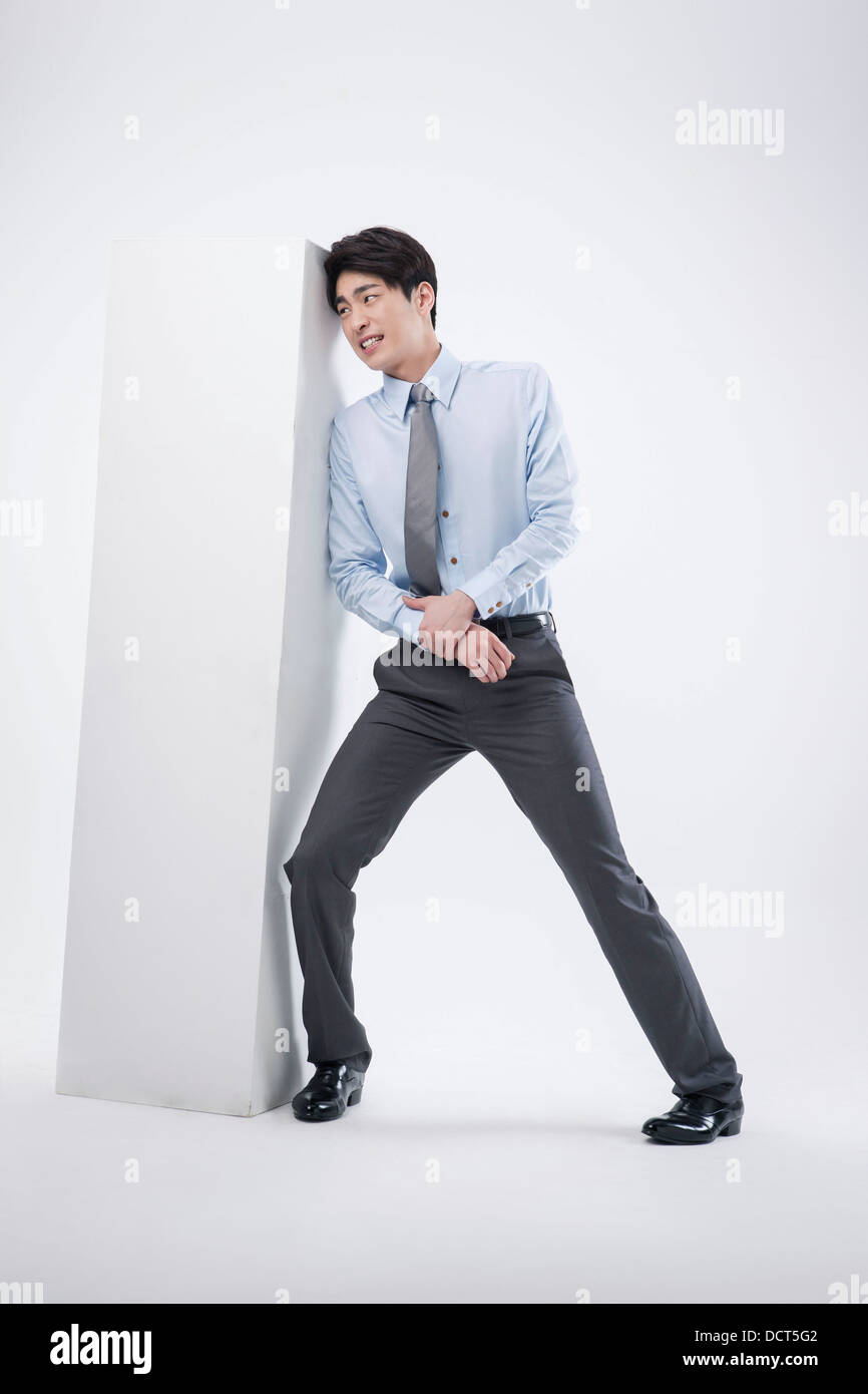 a business man leaning at a block Stock Photo - Alamy
