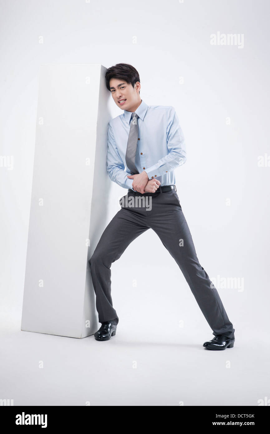 a business man leaning at a block Stock Photo - Alamy