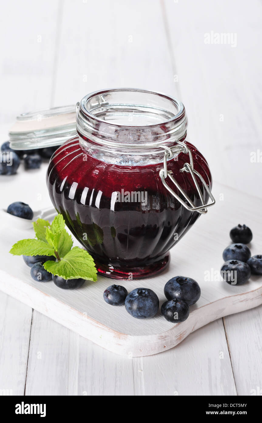blueberry jam in a glass jar on white wooden background Stock Photo - Alamy
