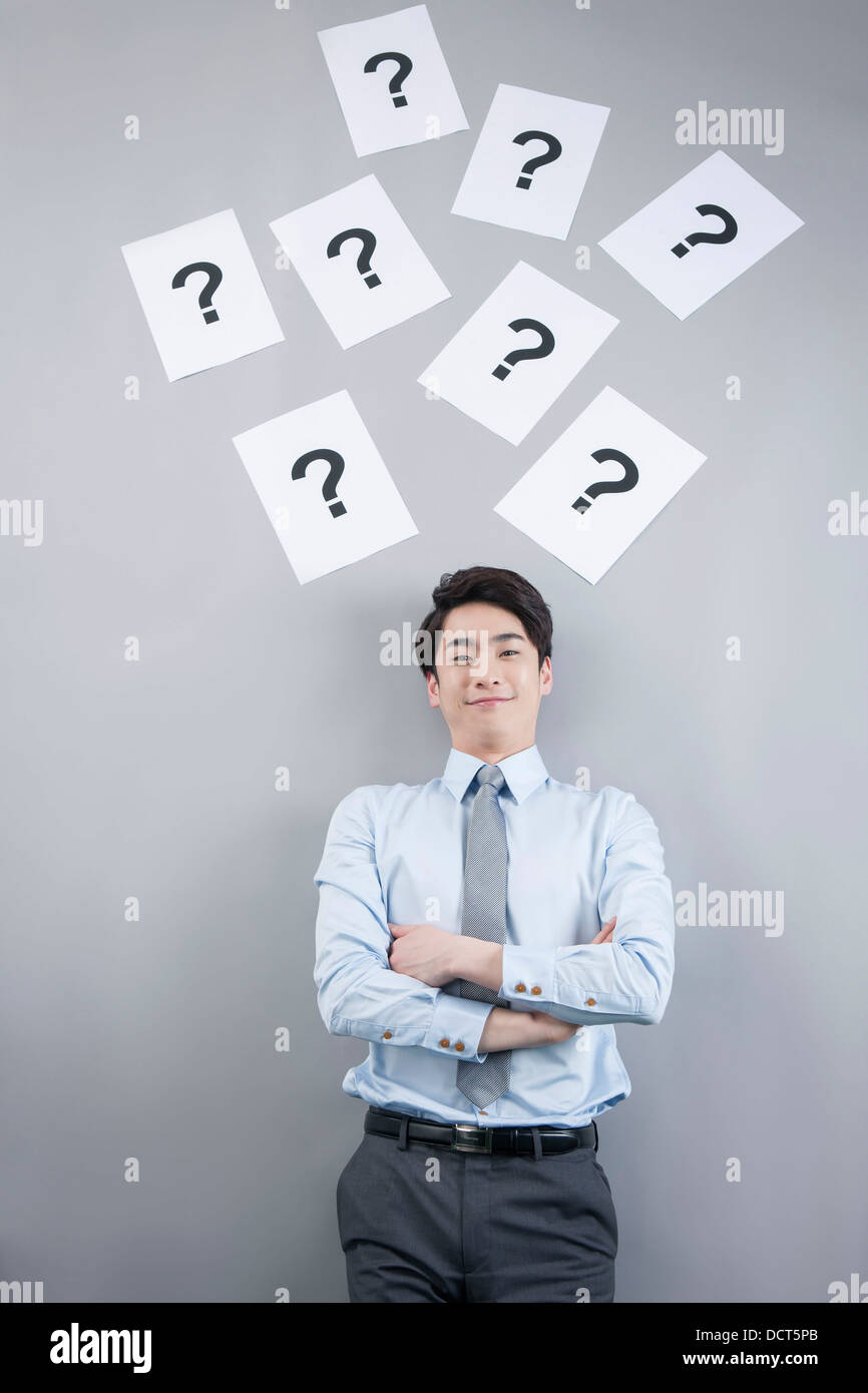 a business man with papers that has a question mark Stock Photo - Alamy