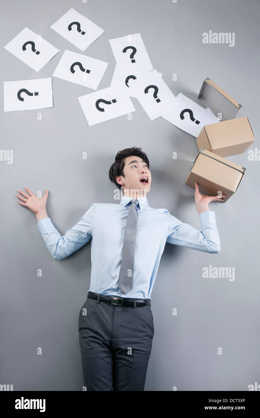 a business man with papers that has a question mark Stock Photo - Alamy