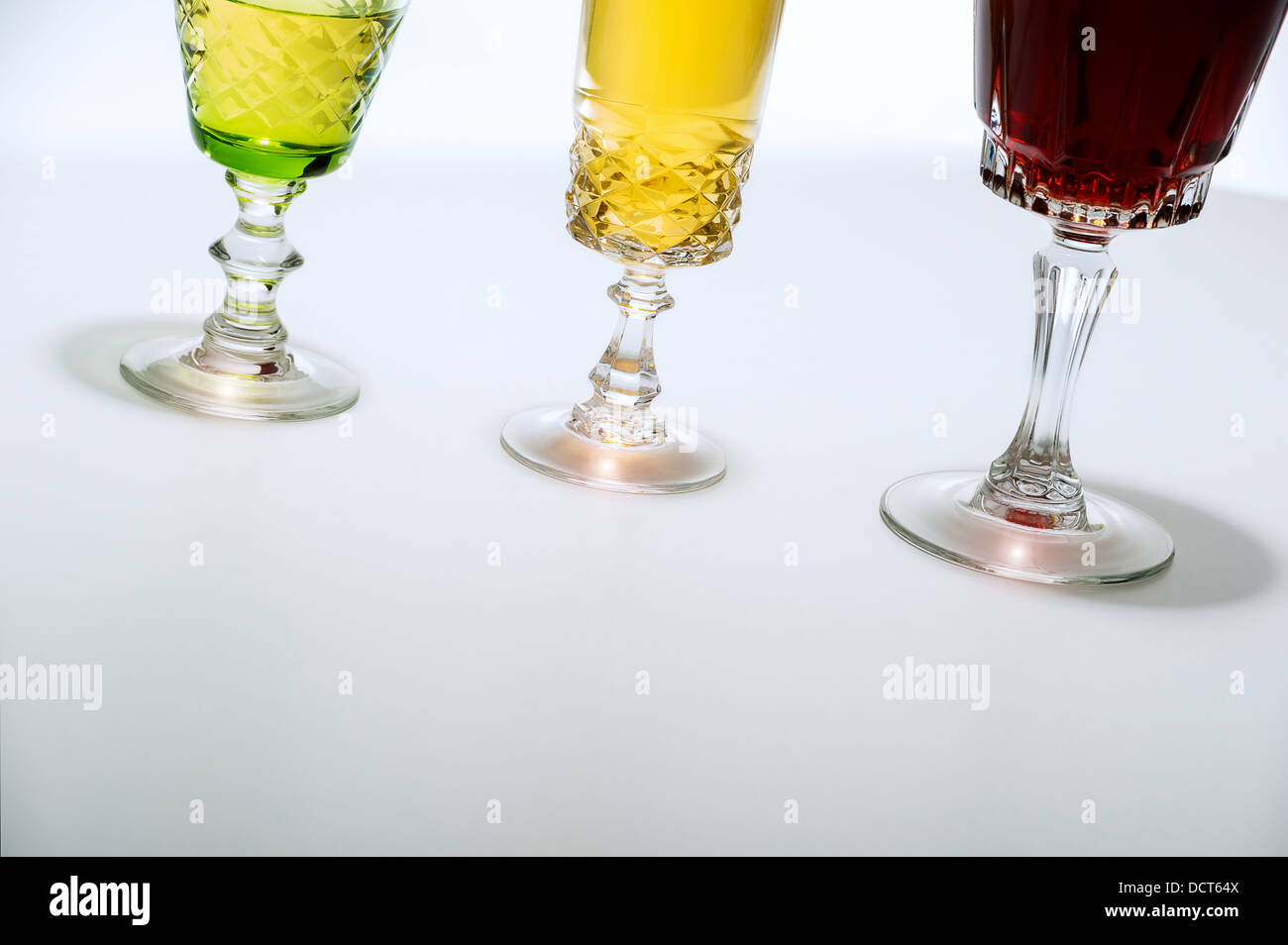 Low angle crop of three cut glass wine glasses Stock Photo - Alamy