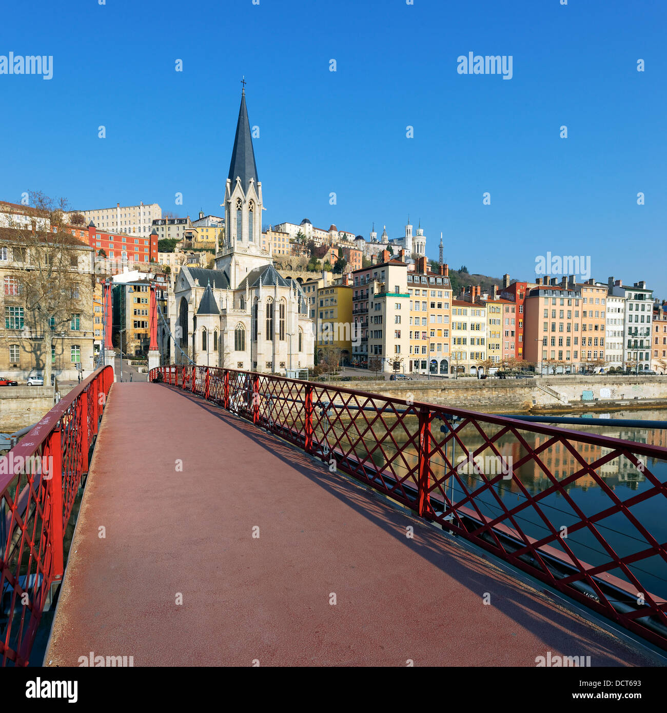 red footbridge and church Stock Photo - Alamy
