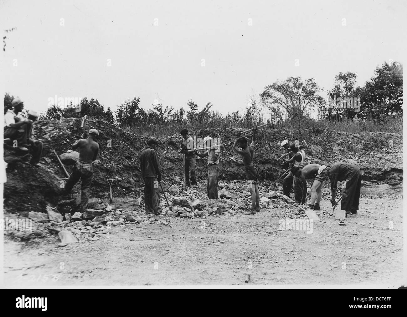 Civilian Conservation Corps (CCC) boys are seen quarrying rock for dam ...