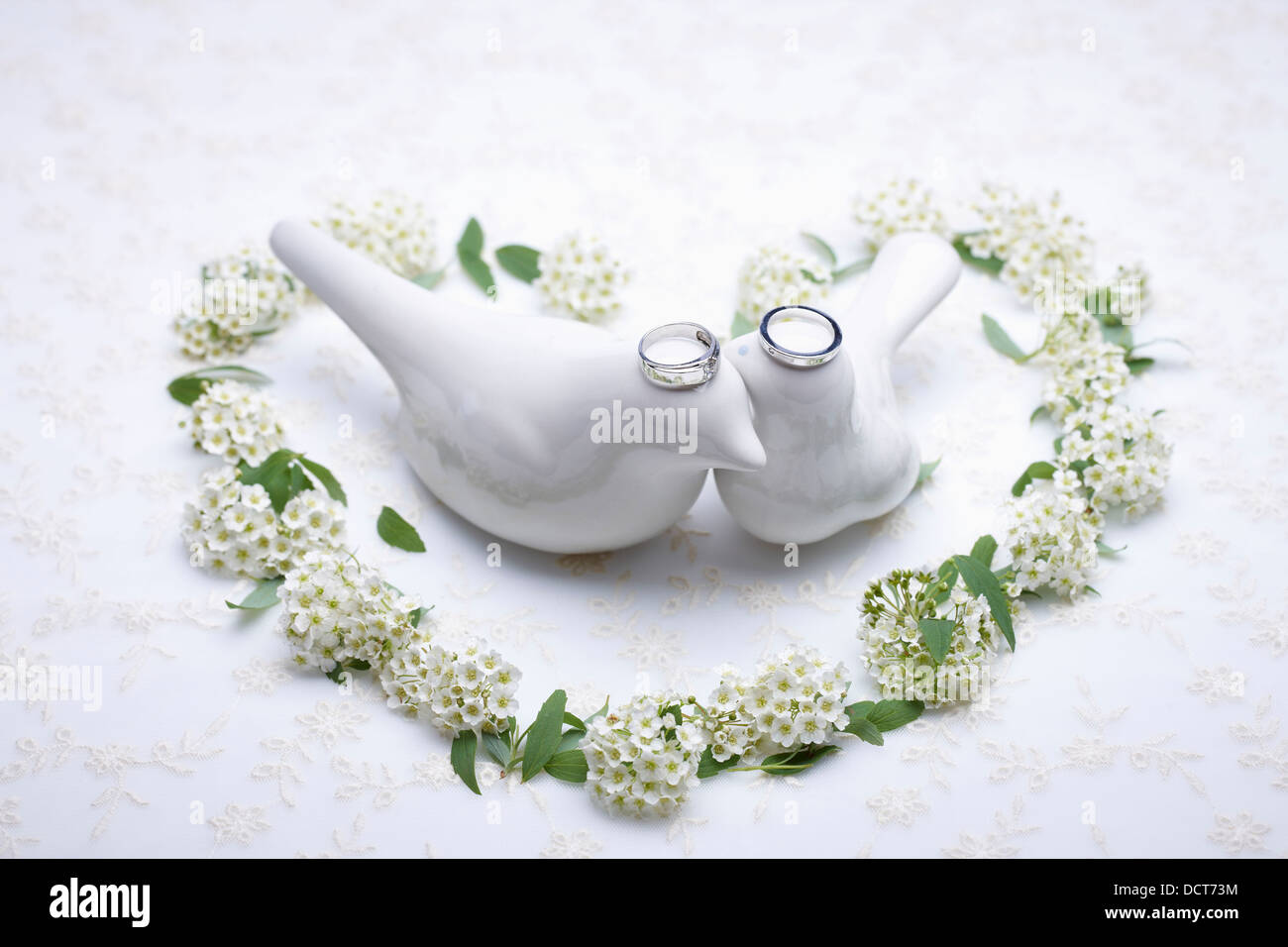 wedding rings on porcelain birds Stock Photo - Alamy