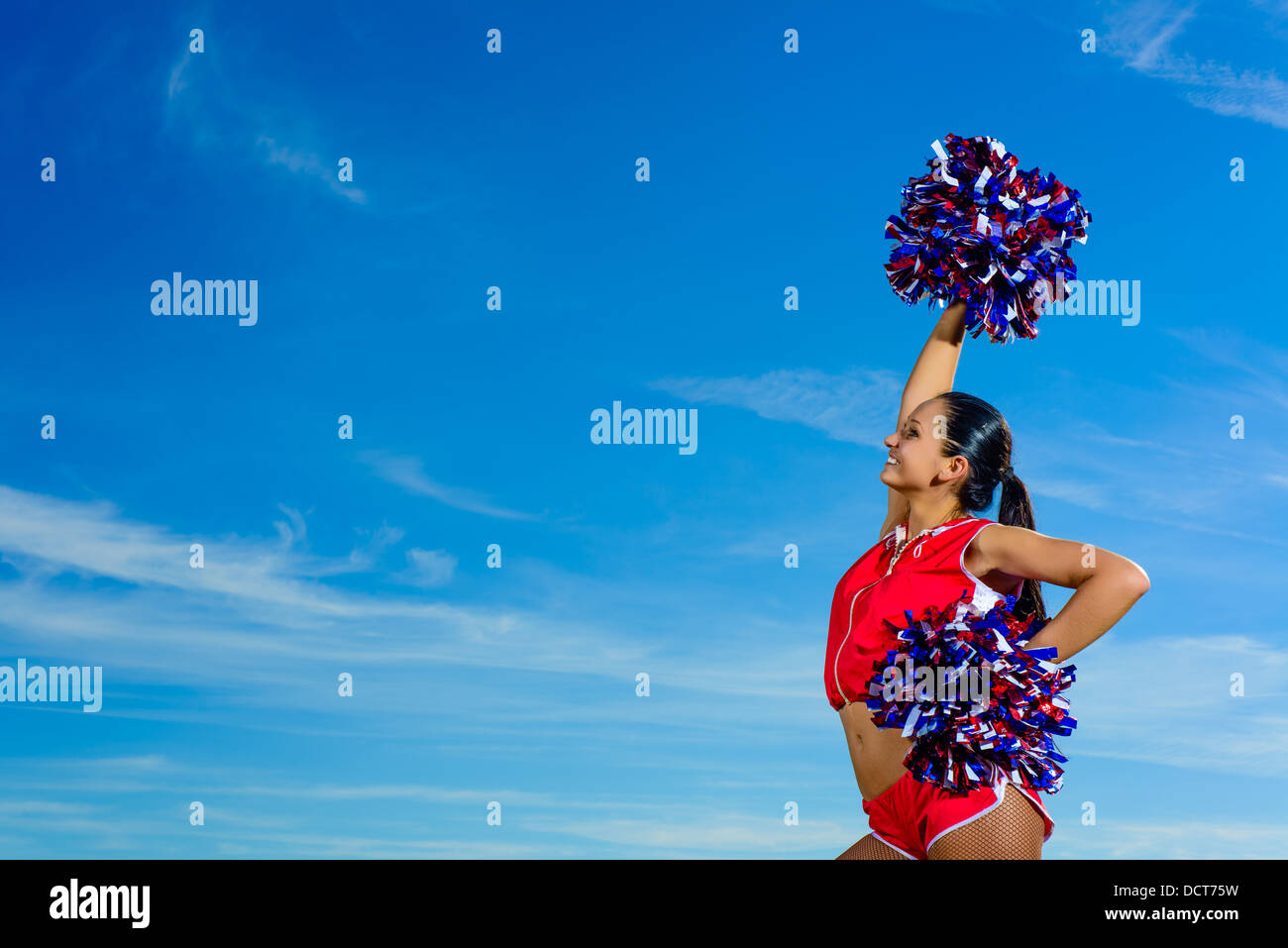 Young cheerleader in red costume with pampon Stock Photo - Alamy