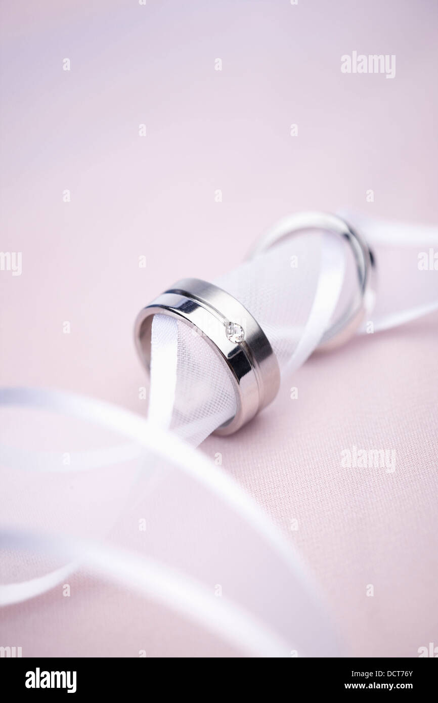 wedding rings in a white ribbon Stock Photo - Alamy