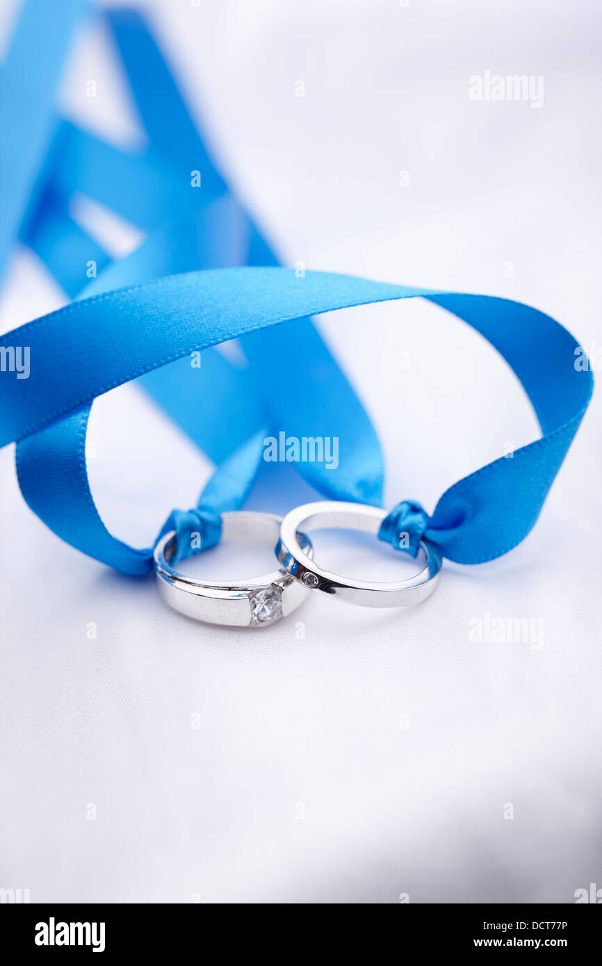 wedding rings in a blue ribbon Stock Photo - Alamy