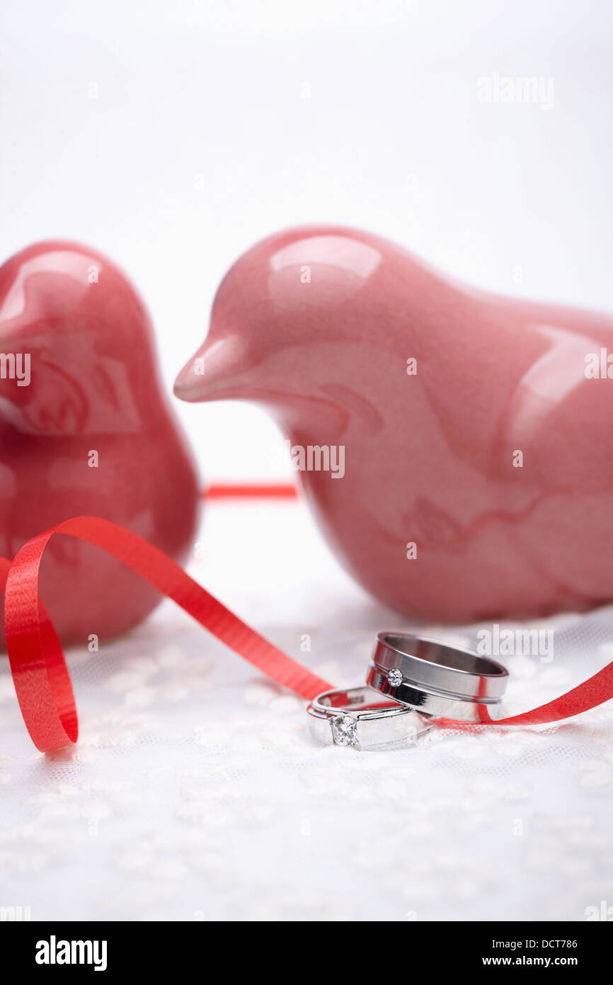 red porcelain birds, red ribbon and wedding rings Stock Photo - Alamy