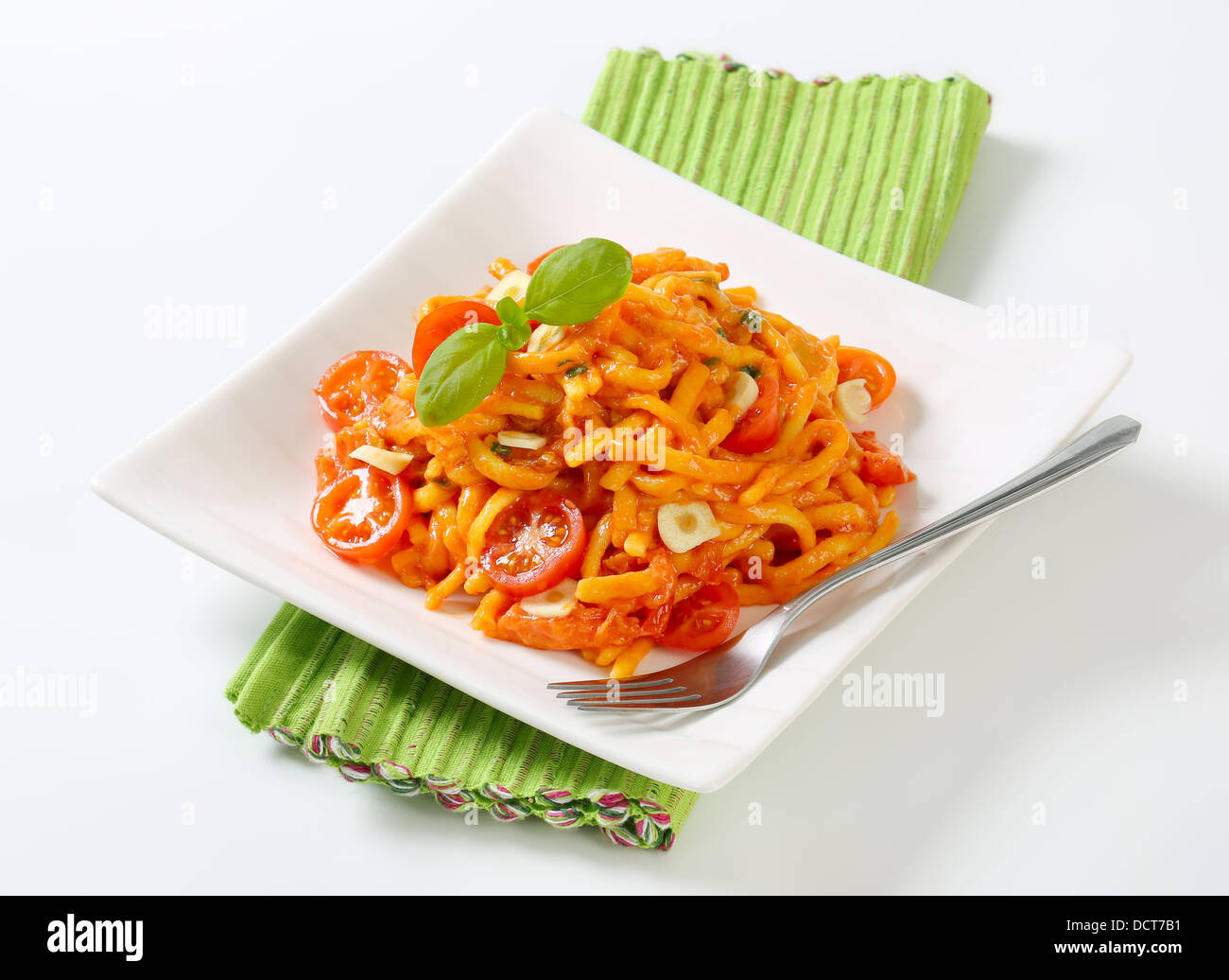 Thin spaetzle in garlic tomato sauce Stock Photo - Alamy