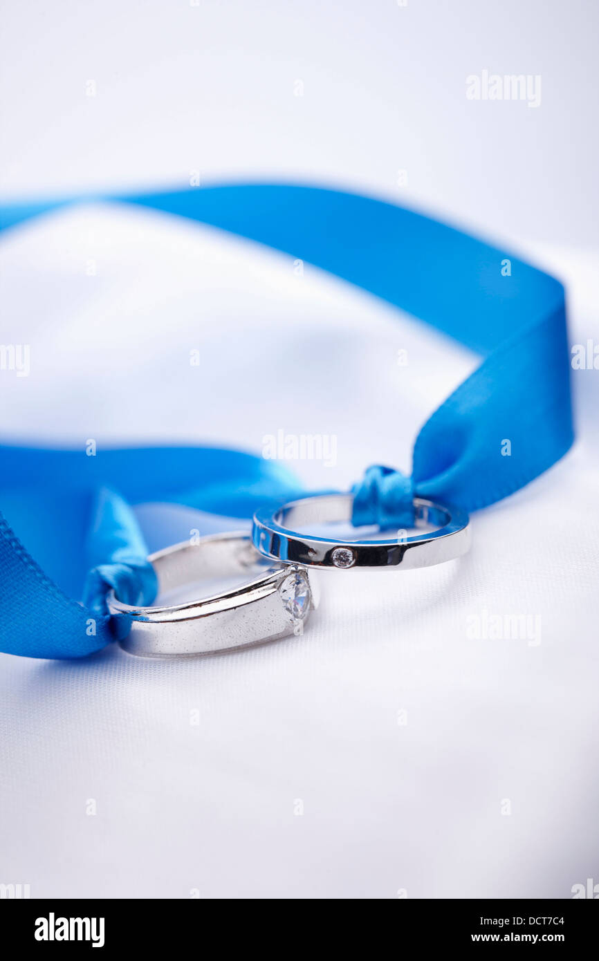 wedding rings in a blue ribbon Stock Photo - Alamy