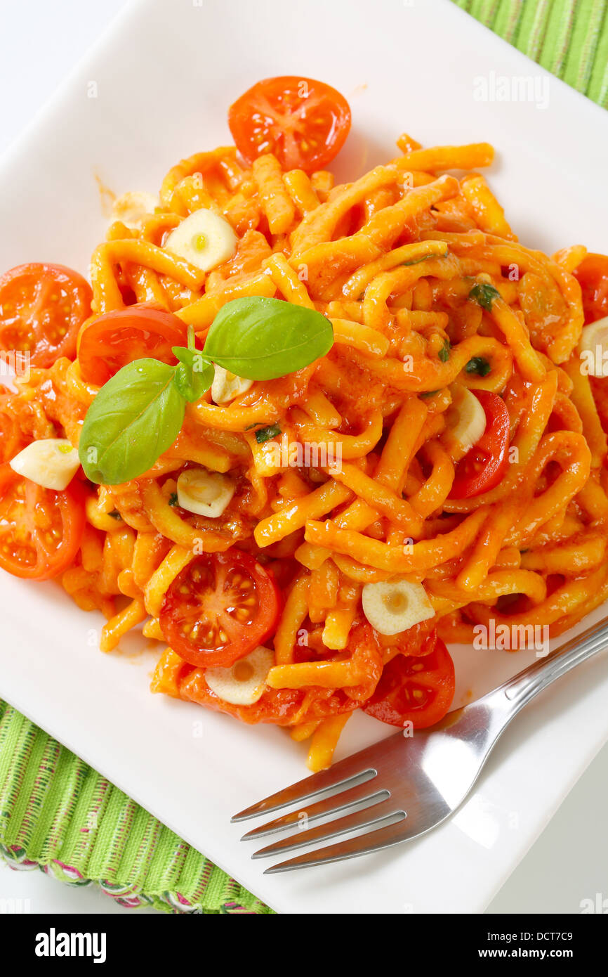 Thin spaetzle in garlic tomato sauce Stock Photo - Alamy