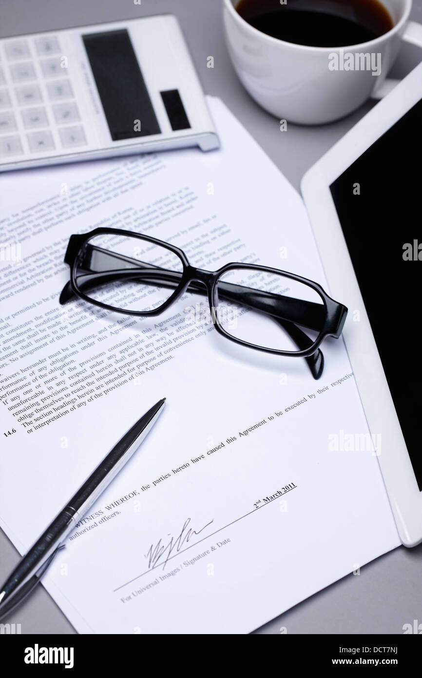 a coffee cup, a tablet and papers Stock Photo - Alamy